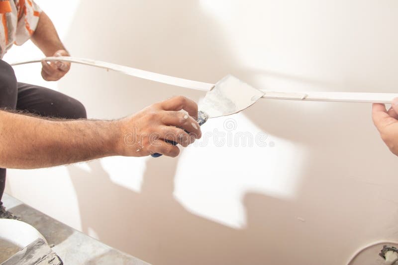 Worker Applying Putty on Material. Renovating Home Stock Photo - Image ...