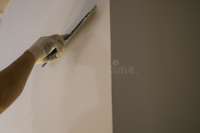 Worker Applying Putty on the Wall with Putty Knife Stock Photo - Image ...
