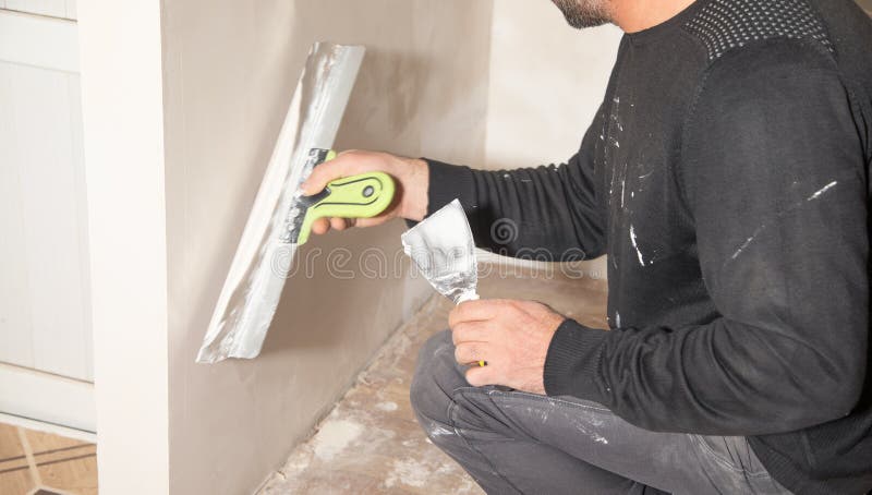 Worker is Applying Putty on a Wall. Renovating House Stock Image ...
