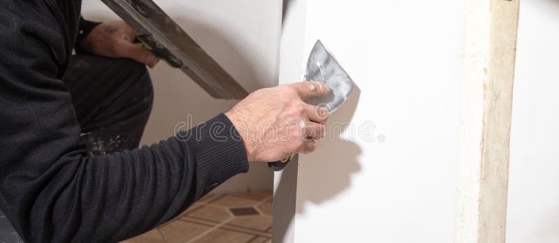 Worker is Applying Putty on a Wall. Renovating House Stock Photo ...