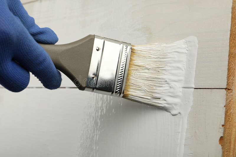Worker Applying White Paint Onto Wooden Surface, Closeup Stock Photo ...