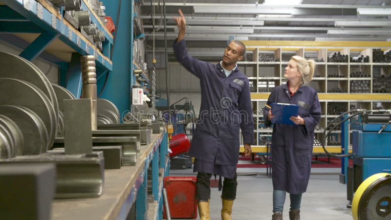Worker and Apprentice Checking Stock Levels in Store Room Stock Video ...