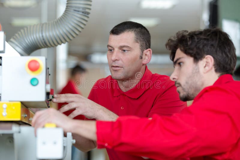 Worker and Apprentice on Industrial Machine Stock Image - Image of ...