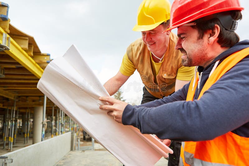 Worker and Architect with Architectural Drawing on Construction Site ...