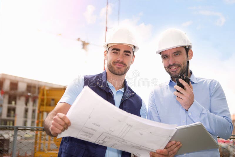 Worker and Architect Watching Some Details on a Construction Stock ...