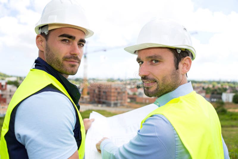 Worker and Architect Watching Some Details on a Construction Stock ...