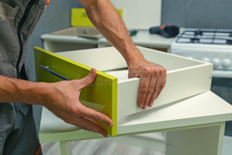 Worker Assembles Furniture in the Kitchen. Stock Photo - Image of ...