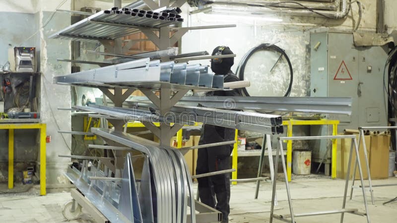 A Worker Assembles Metal Structures at a Factory. Industrial ...