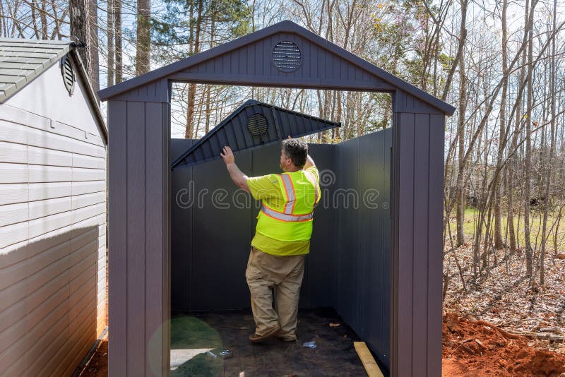 Worker Assembling Plastic Vinyl Storage Sheds for Backyards Near His ...