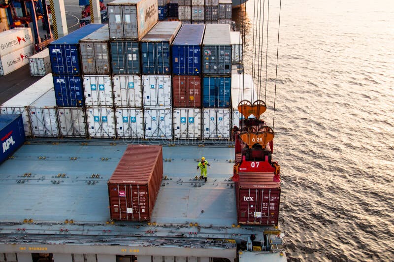 Worker Assisting Container Uploading At Dock Editorial Image - Image of ...