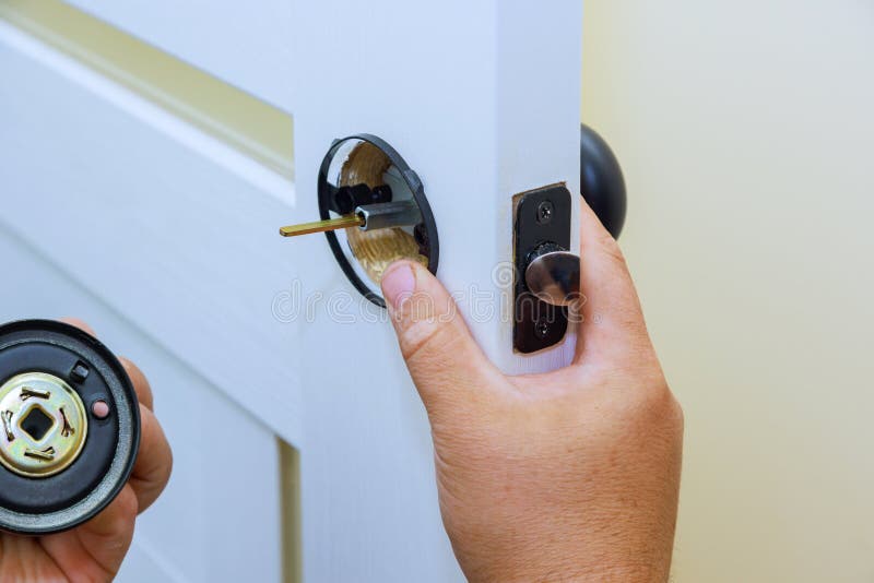 With Worker Attaches a Lock To New Interior Door. Stock Image - Image ...