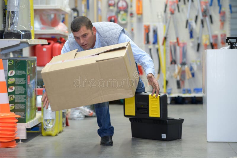 Worker while Lifting Box in Warehouse Stock Photo - Image of packaging ...