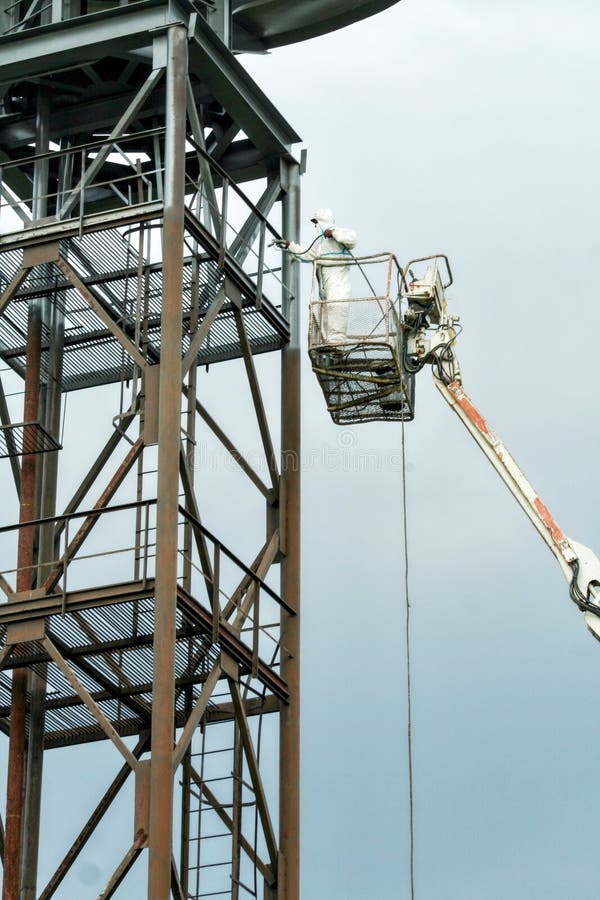 Worker in the Basket of a Lifting Machine Paints a Metal Frame at ...