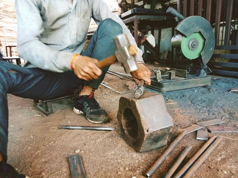 Worker Beating or Hit a Iron Piece To Give a Shape in Iron Workshop ...