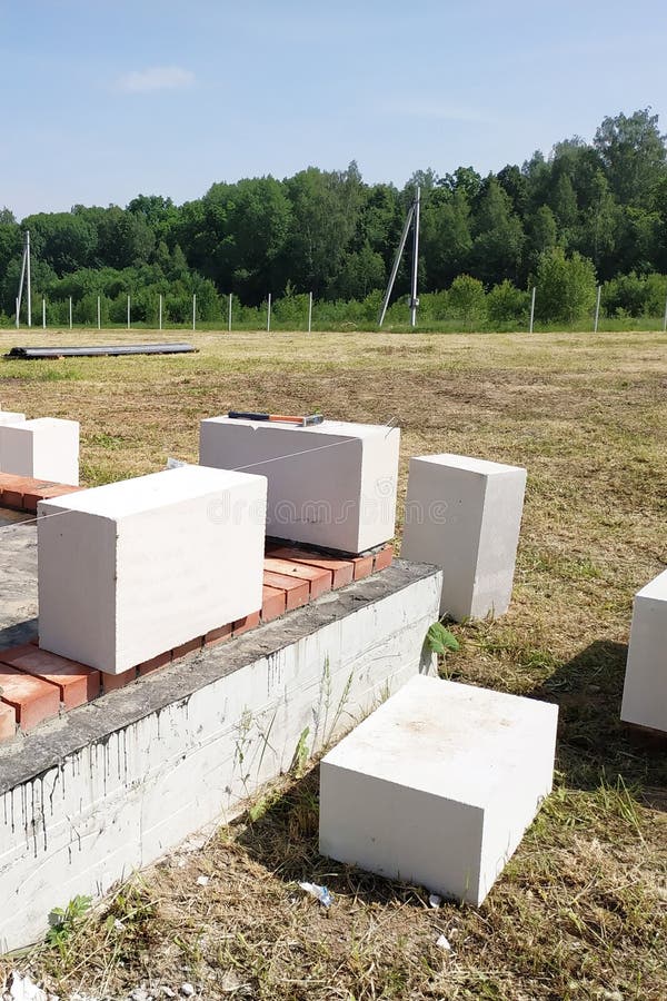 The Worker Begins the First Row of Masonry Construction in White Gas ...