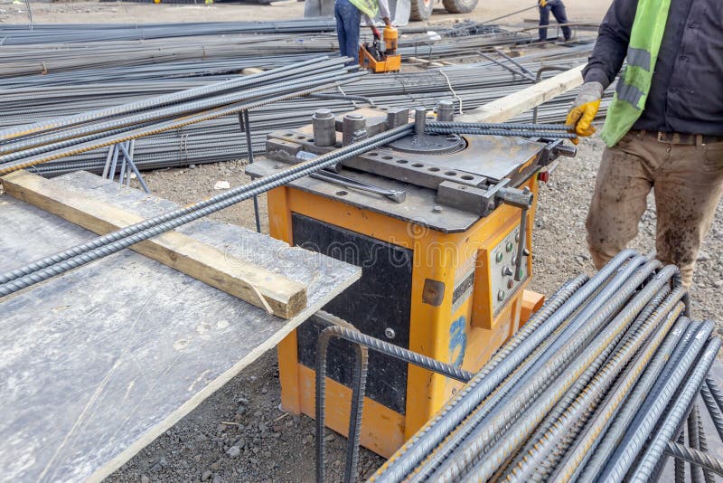 The Worker is Bending Rebars Rods in the Construction Site. Stock Photo ...