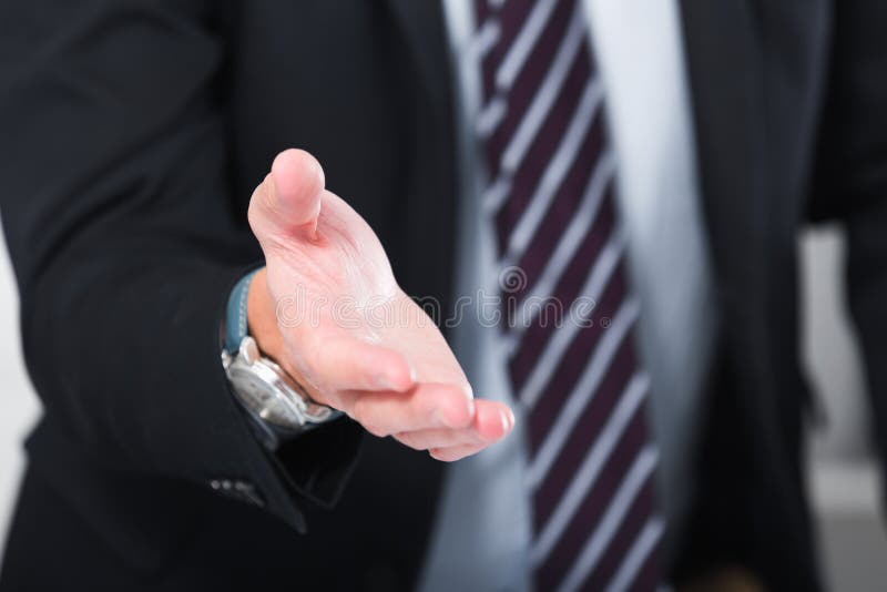 Worker in Black Suit Offering One S Hand Stock Photo - Image of ...