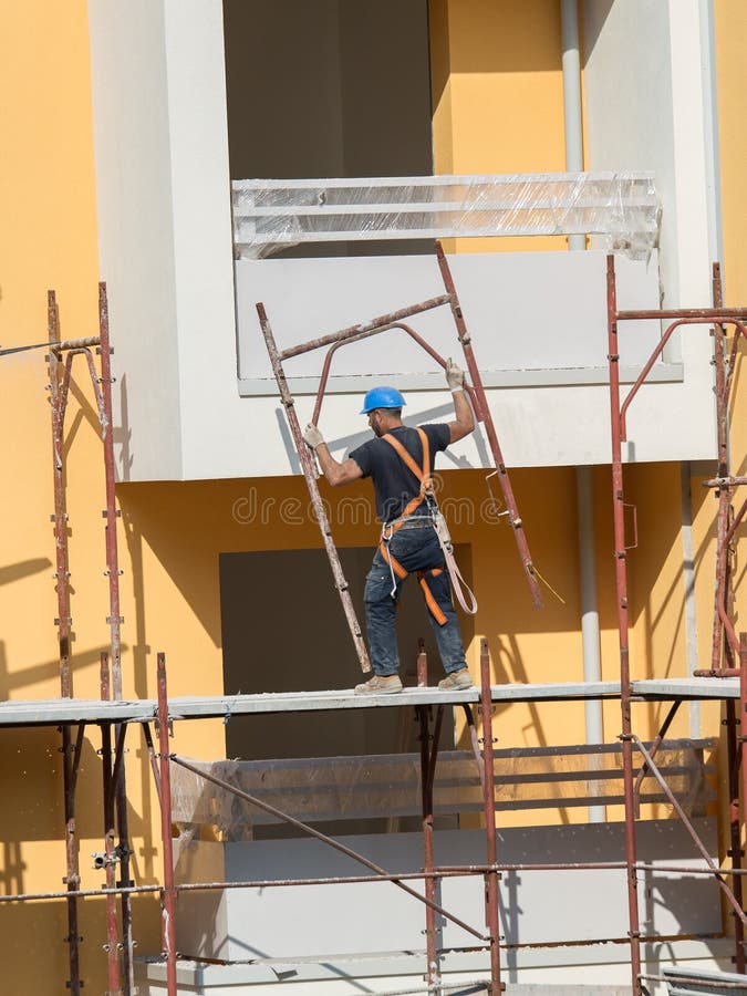 Parma, Italy - May 2019: Worker with Blue Hardhat at Work on a Scaffold ...