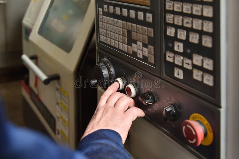 Worker in Blue Workwear Holds Hands on the Control Panel of the CNC ...