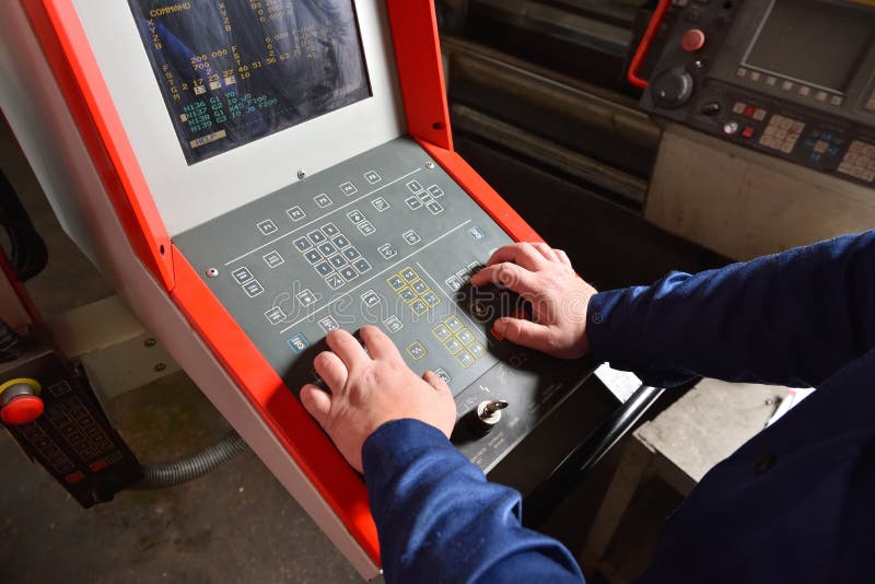 Worker in Blue Workwear Holds Hands on the Control Panel of the CNC ...