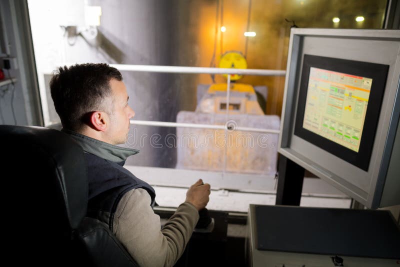 Worker in Booth Controlling Production Via Computer Stock Image - Image ...