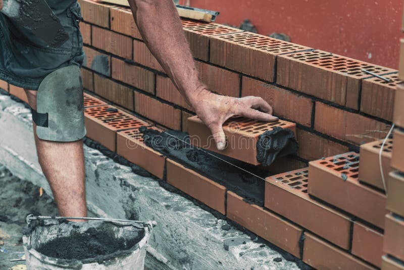 Worker or Bricklayer Laying Bricks. Builder Makes Brickwork on ...
