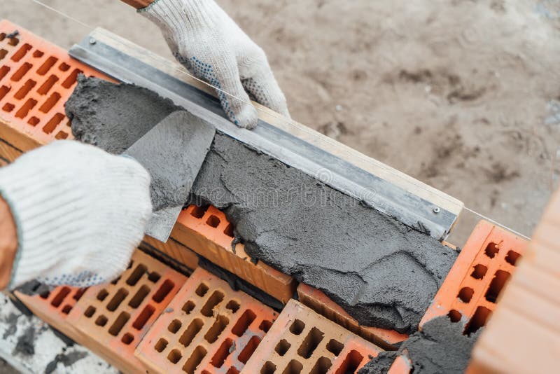 Worker or Bricklayer Works with Trowel Laying Bricks. Builder Makes ...