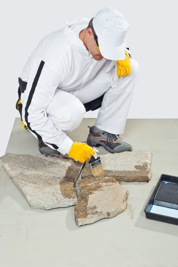 Worker Brush Primer Grout of Stones Stock Image - Image of materials ...