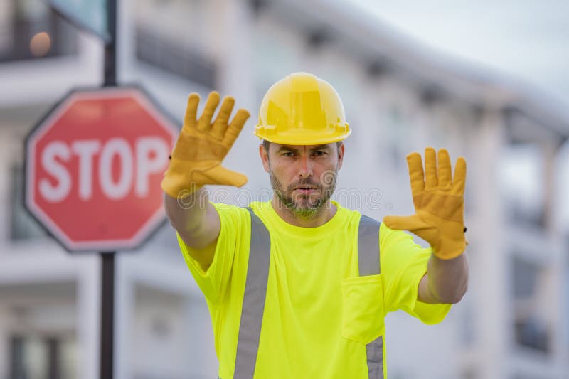 Worker Builder in Hard Hat with Stop Road Sign. Builder with Stop ...