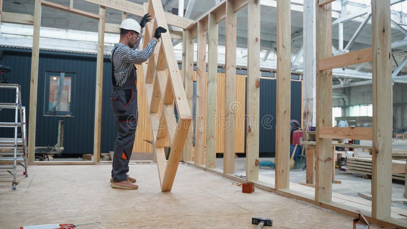 Worker Builder Installing Wooden Frame in Prefabricated Modular House ...