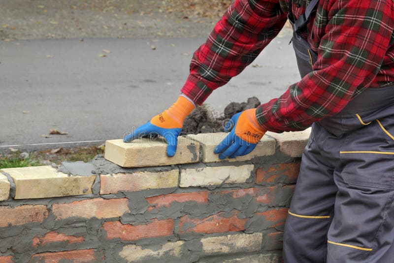 Worker building brick wall stock image. Image of house - 107999393