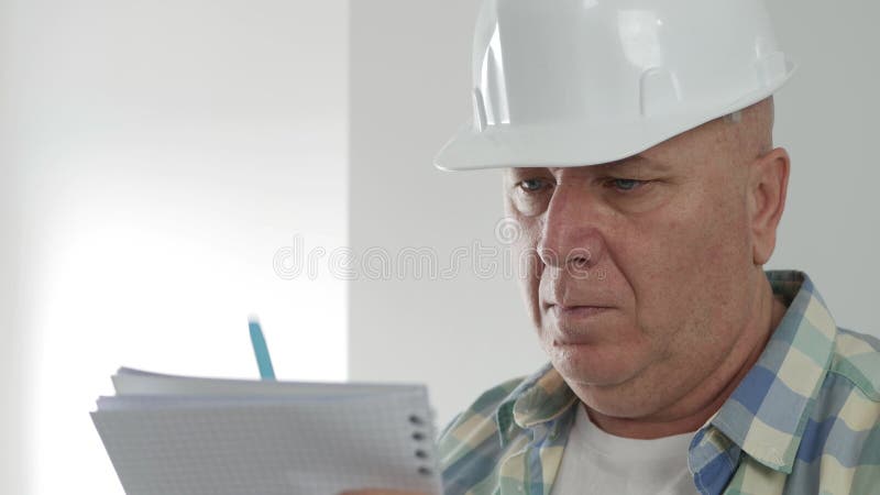 Worker in Building Industry Drawing a Work Plan on the Paper ...
