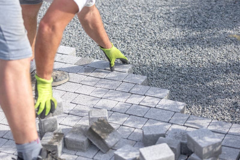 Worker Building a New Interlocking Pavement from Concrete Paving, a New ...