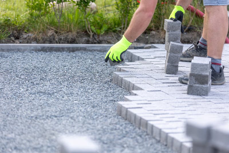 Worker Building a New Interlocking Pavement from Concrete Paving, a New ...