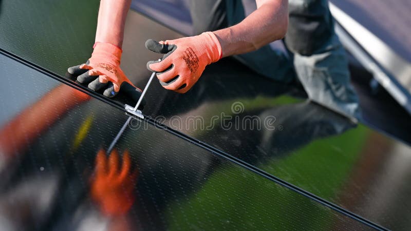 Worker Building Photovoltaic Solar Panel System on Rooftop of House ...