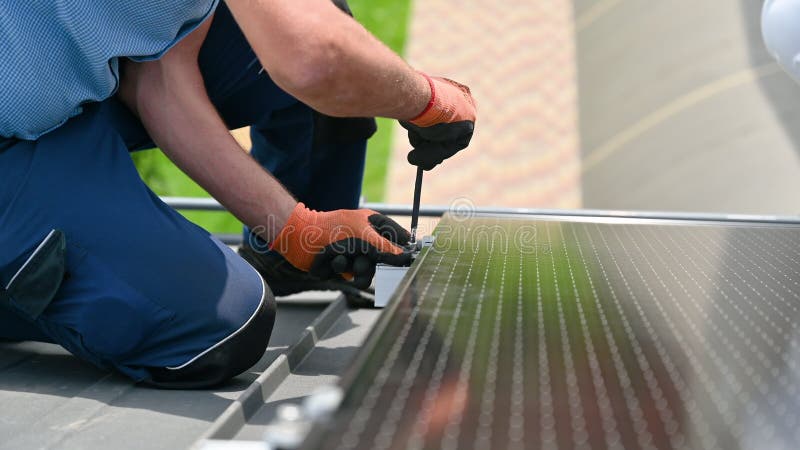 Worker Building Photovoltaic Solar Panel System on Rooftop of House ...
