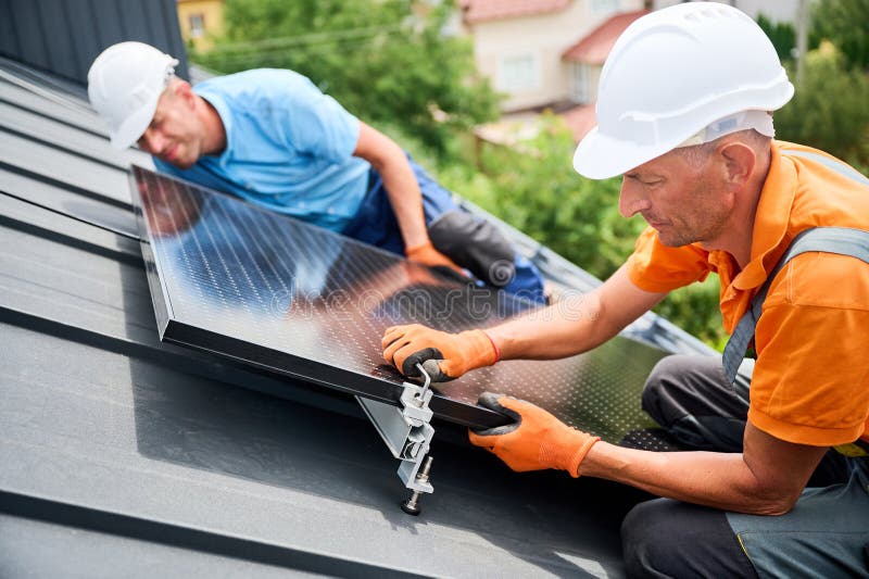 Worker Building Photovoltaic Solar Panel System on Rooftop of House ...