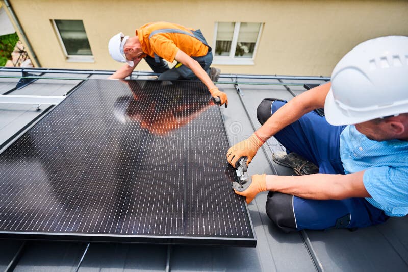 Worker Building Photovoltaic Solar Panel System on Rooftop of House ...