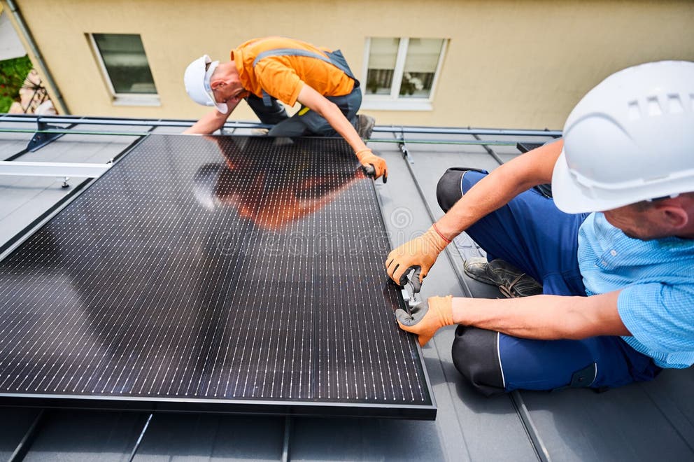 Worker Building Photovoltaic Solar Panel System on Rooftop of House ...