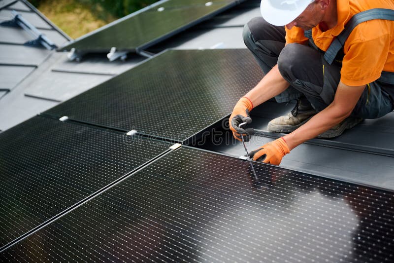 Worker Building Photovoltaic Solar Panel System on Rooftop of House ...
