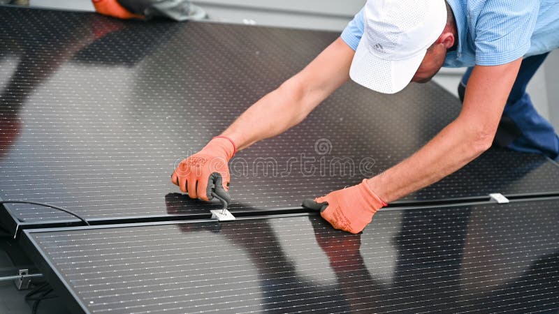 Worker Building Photovoltaic Solar Panel System on Rooftop of House ...