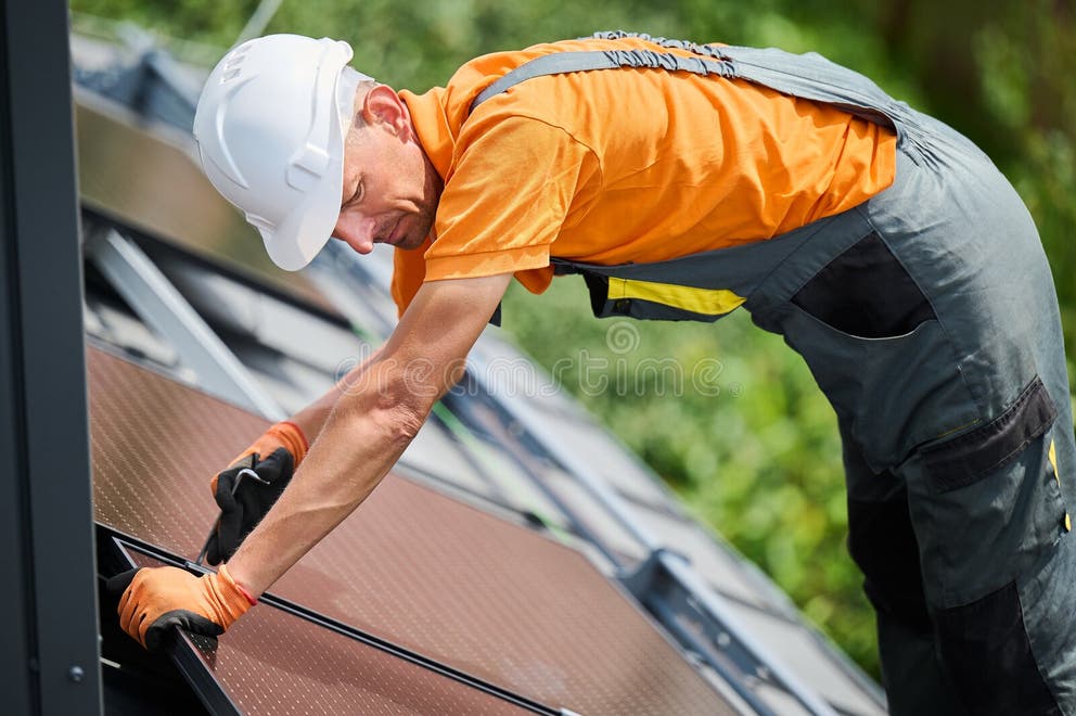 Worker Building Photovoltaic Solar Panel System on Rooftop of House ...