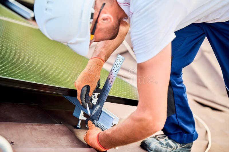 Worker Building Photovoltaic Solar Panel System, Using Ruler To Measure ...