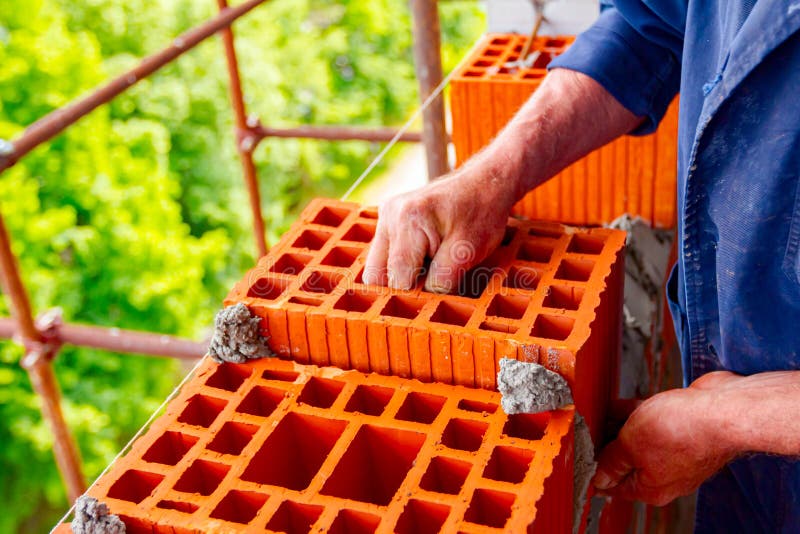 Worker is Building Wall with Red Blocks and Mortar Stock Photo - Image ...
