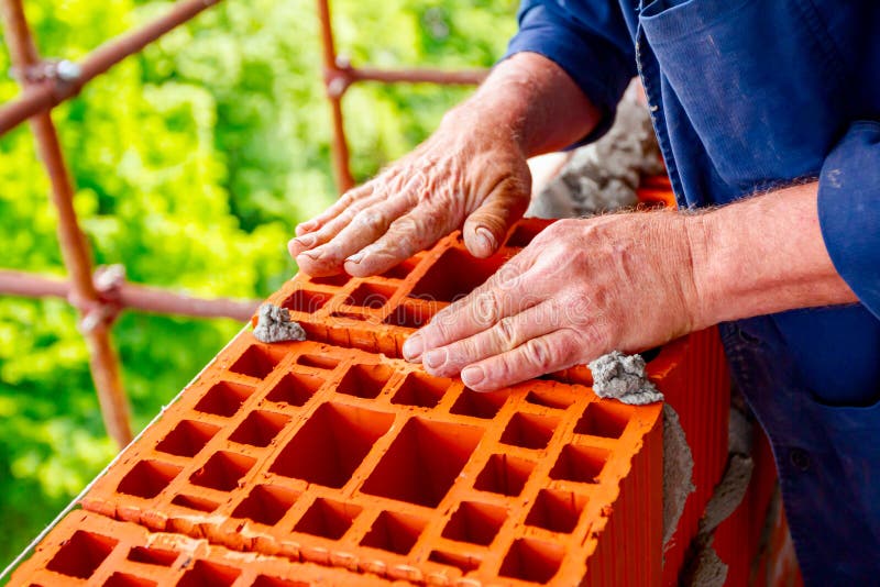 Worker is Building Wall with Red Blocks and Mortar Stock Photo - Image ...