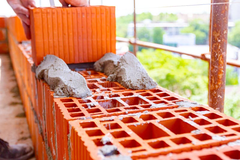 Worker is Building Wall with Red Blocks and Mortar Stock Photo - Image ...