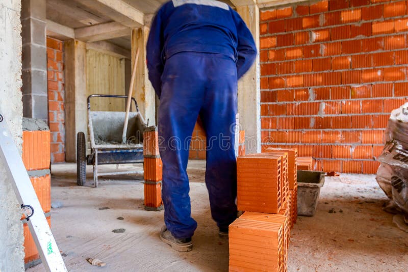 Worker is Building Wall with Red Blocks and Mortar Stock Image - Image ...