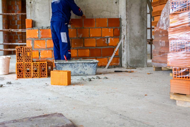 Worker is Building Wall with Red Blocks and Mortar Stock Image - Image ...
