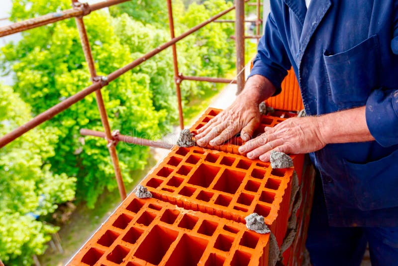 Worker is Building Wall with Red Blocks and Mortar Stock Photo - Image ...
