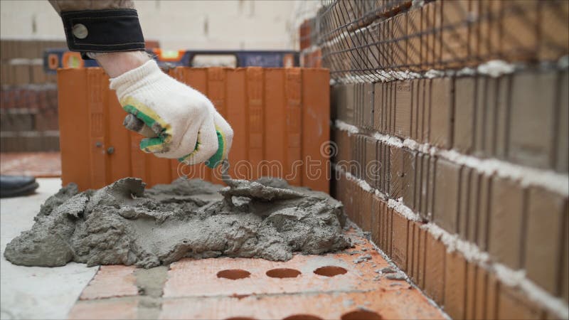 Laying of Red Bricks. a Worker Builds a House Out of Bricks and Mortar ...